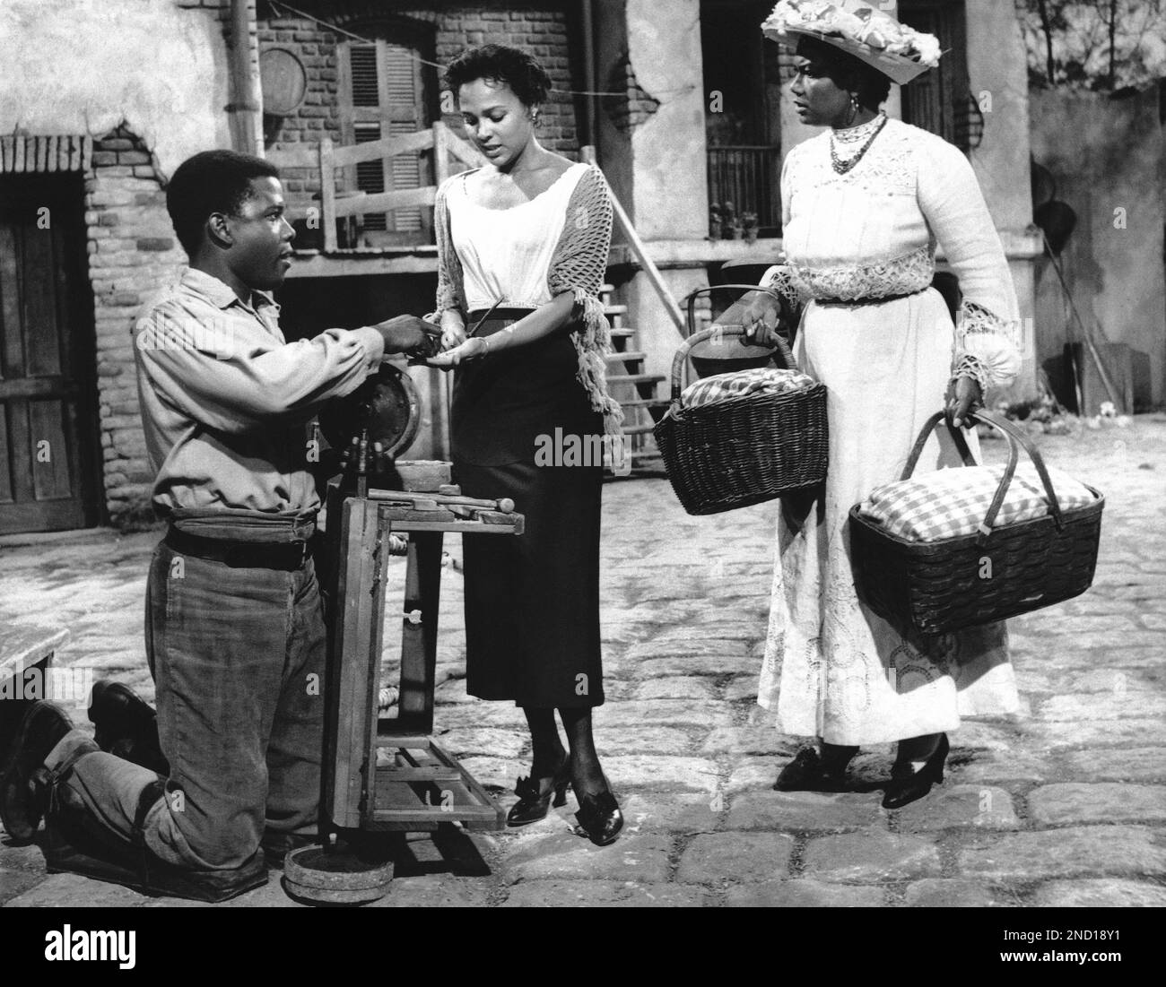 Kneeling on his crippled legs, Porgy, played by Sidney Poitier, urges ...