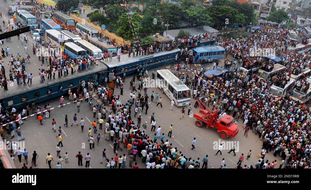People gather after a speeding train plowed into two buses at a busy ...