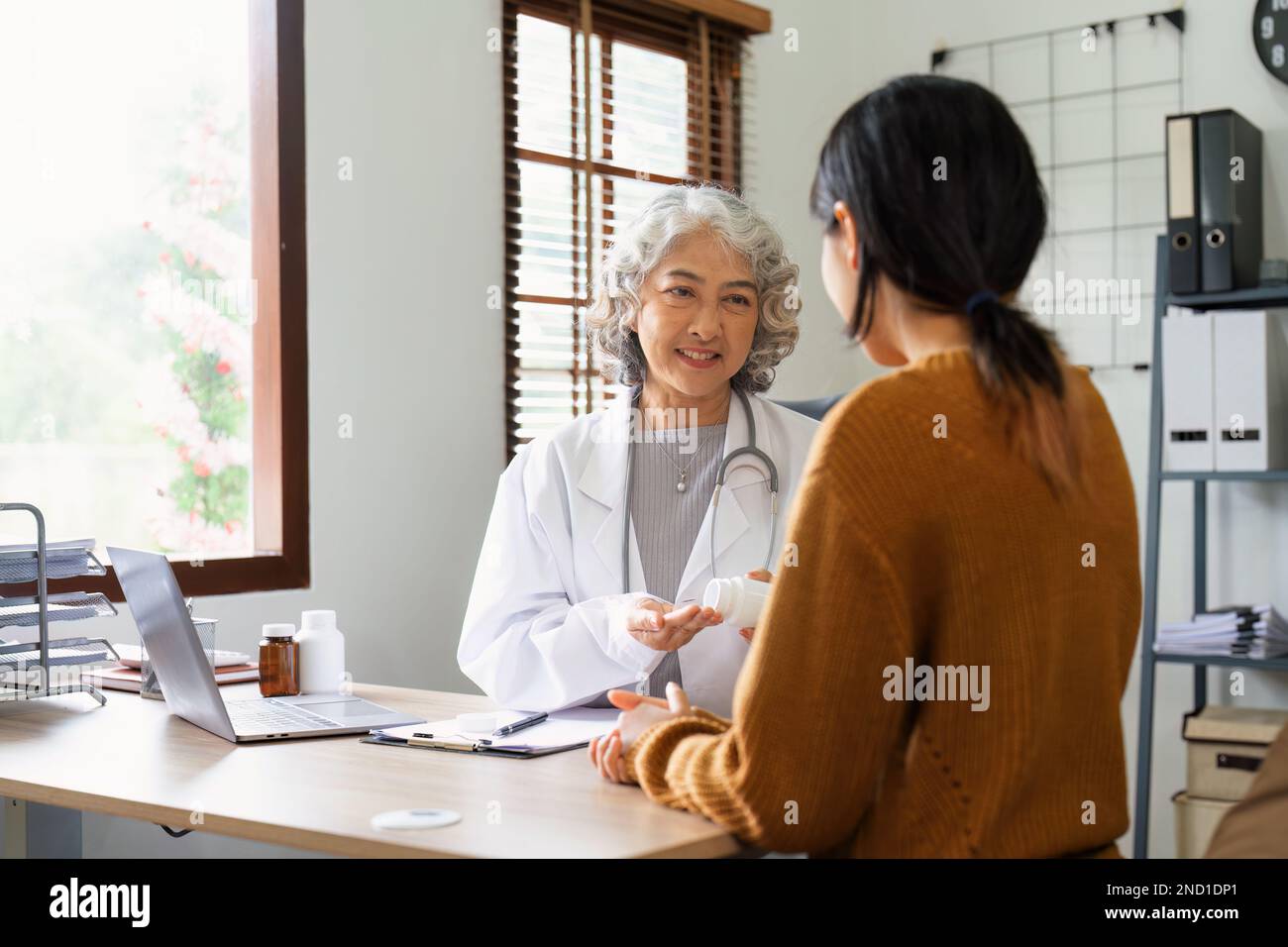 Doctor and patient are discussing at clinic. Digital healthcare and ...