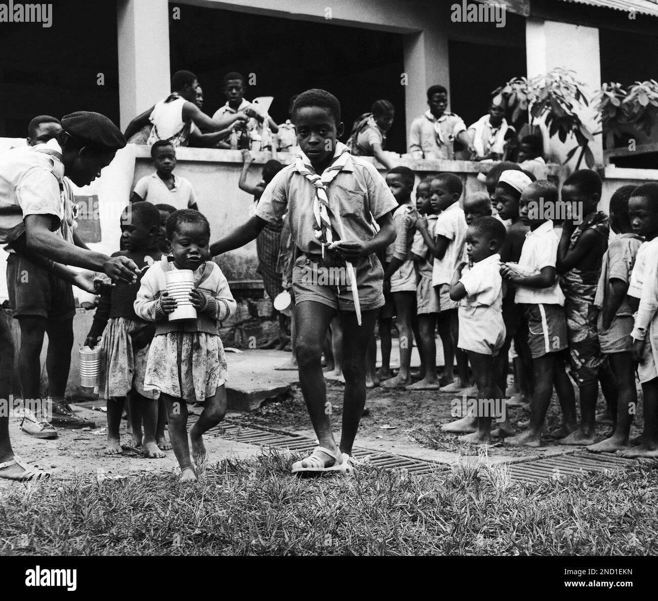 Boys of the Congolese junior Red Cross marshal younger children who ...