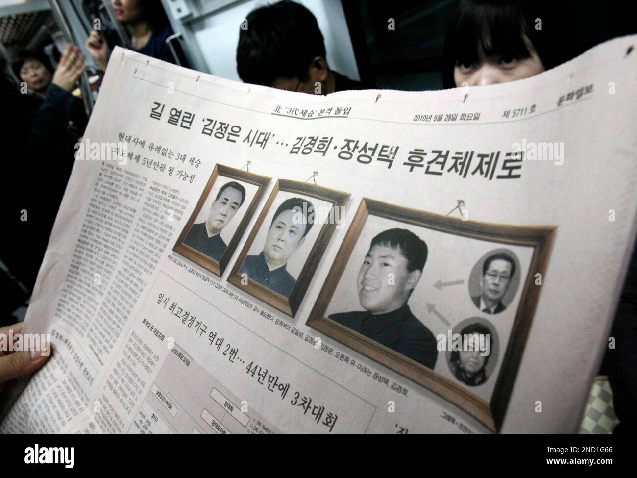 A person reads a South Korean newspaper which shows photos of North ...