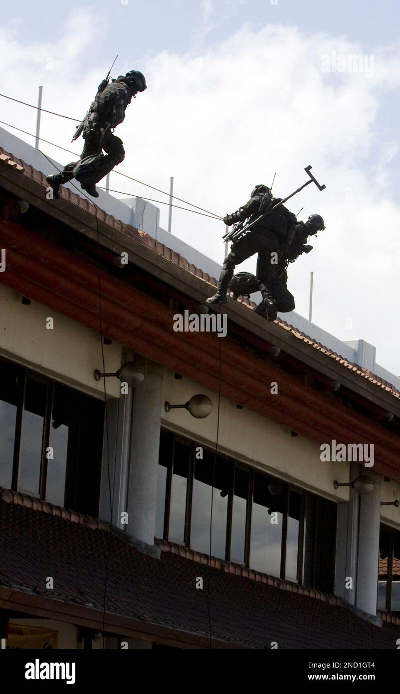 Indonesian Special Forces soldiers, also known as Kopassus, rappel down an airport terminal ...