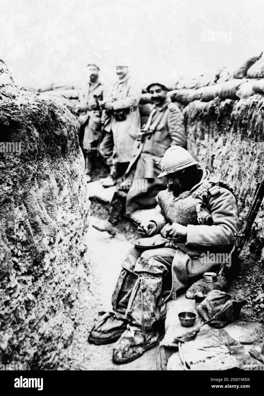 At dinner hour in the trenches of the first line in an undated photo ...