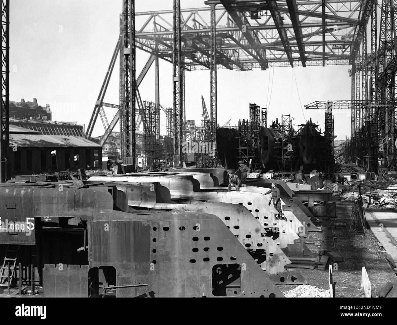 British troops look over some of the many prefabricated parts of ...