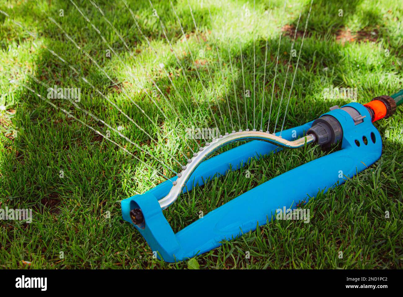 Modern oscillating sprinkler on the mown lawn in the garden Stock Photo ...