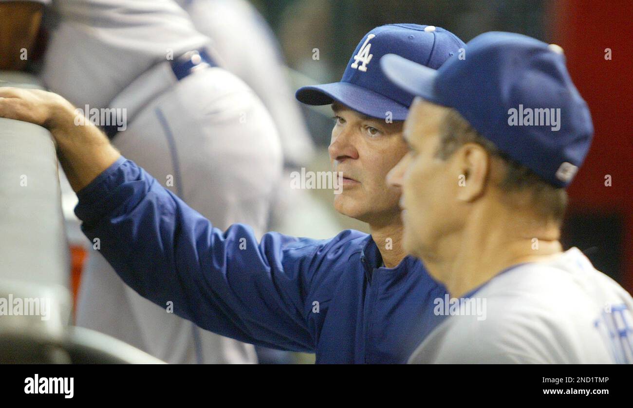 Los Angeles Dodgers coach Don Mattingly, left, looks on from the dugout ...