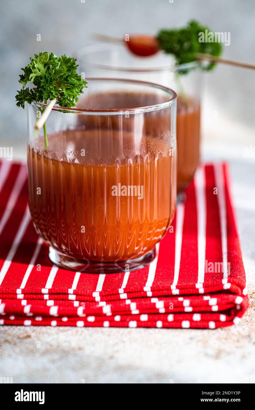 Bloody Mary or Caesar cocktail drink served in the glass on concrete ...