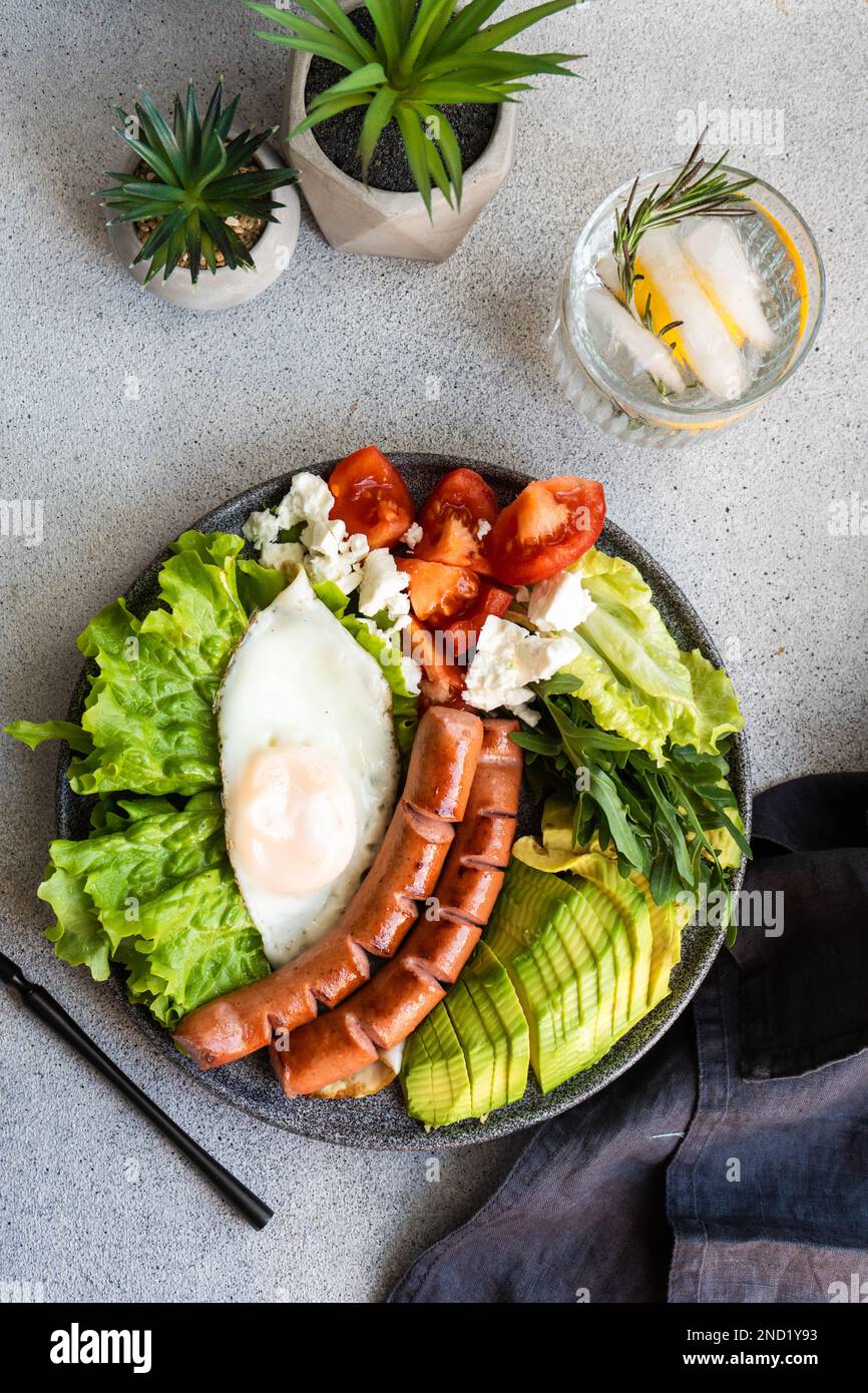 healthy ketogenic lunch plate with vegetables, fried egg and sausages ...
