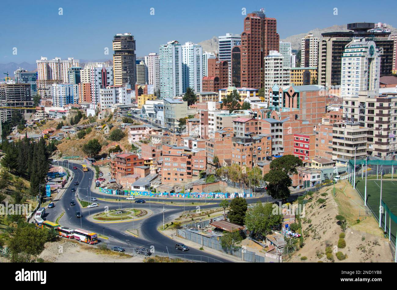 Drone view of modern multistory buildings and asphalt roads going ...
