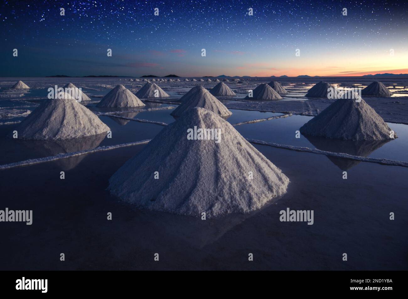 Picturesque scenery of salt formations in lake under starry sky in ...