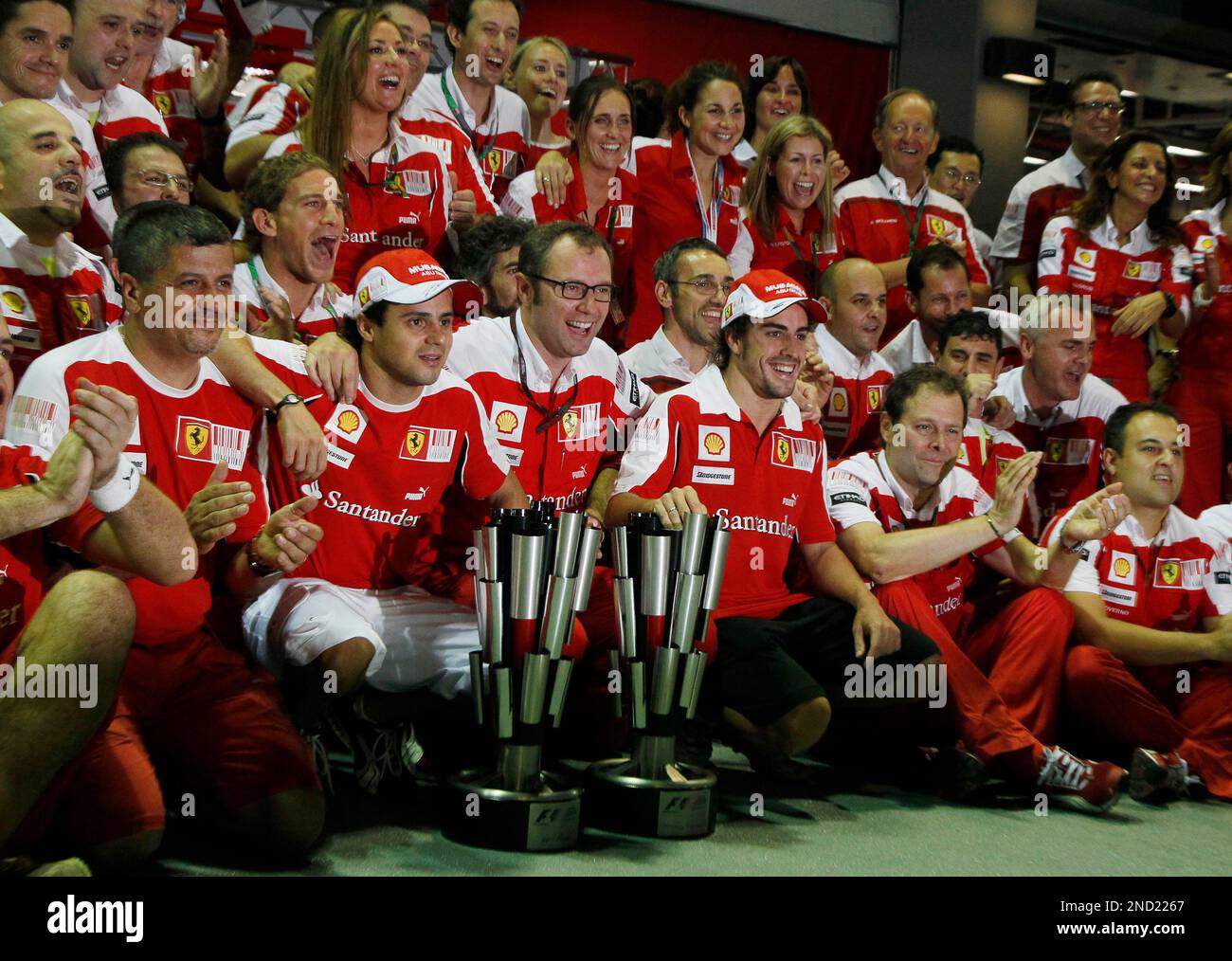 Members of the Ferrari Formula One team pose for a group photo in their ...