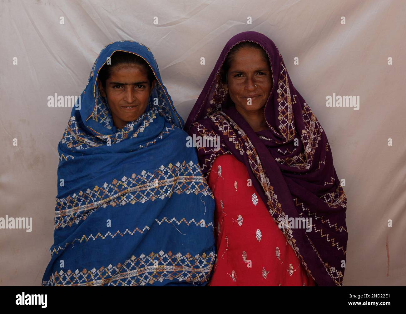 Two Pakistani women who survived recent floods pose for picture at a ...