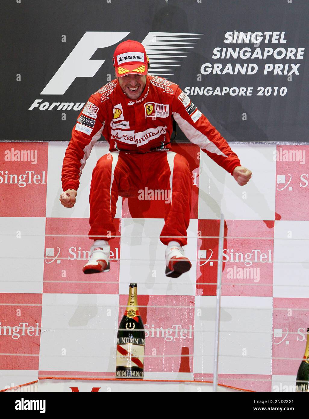 Ferrari Formula One driver Fernando Alonso of Spain leaps as he ...