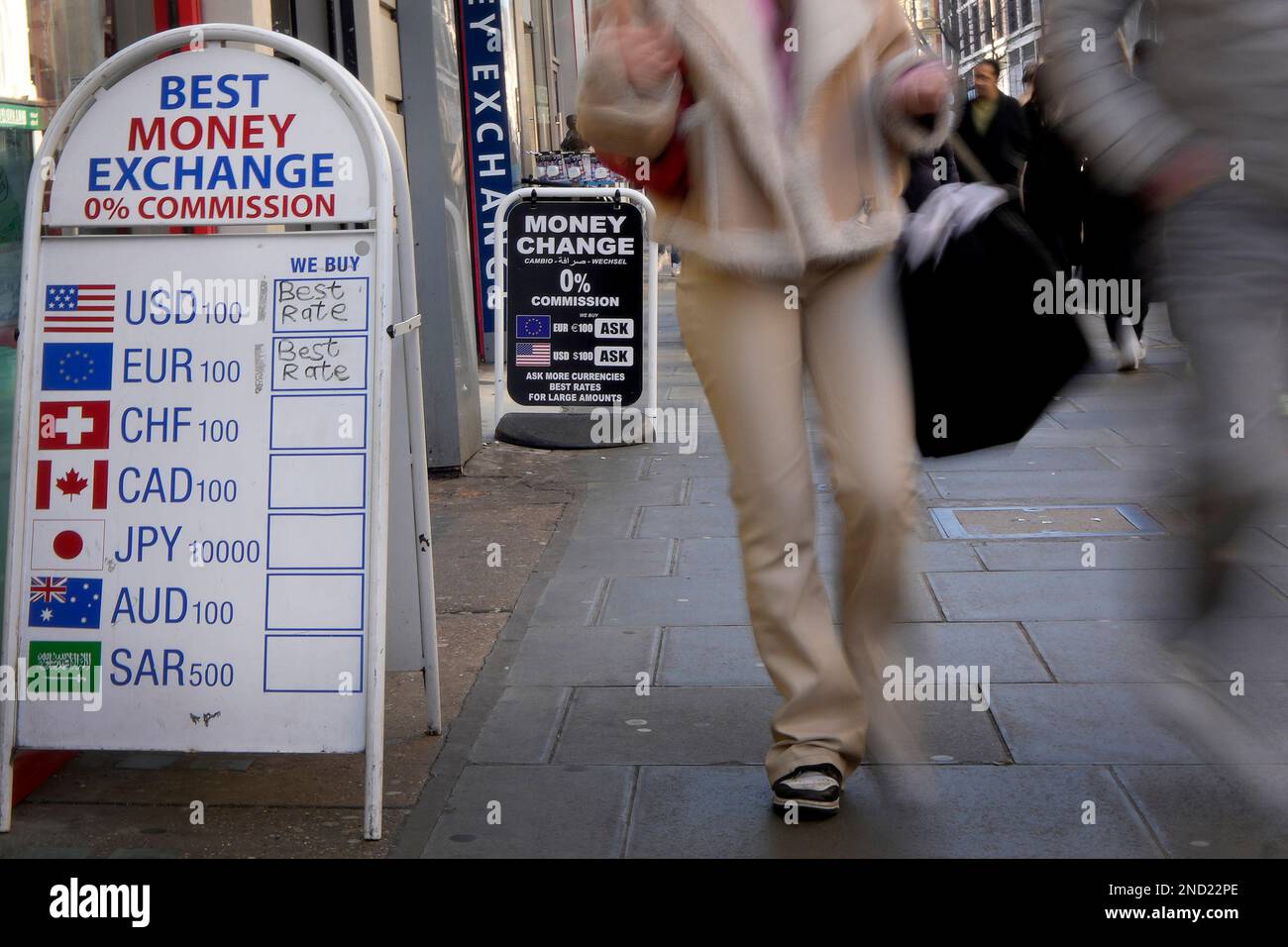 Pedestrians pass money exchange centres on Oxford Street in London ...