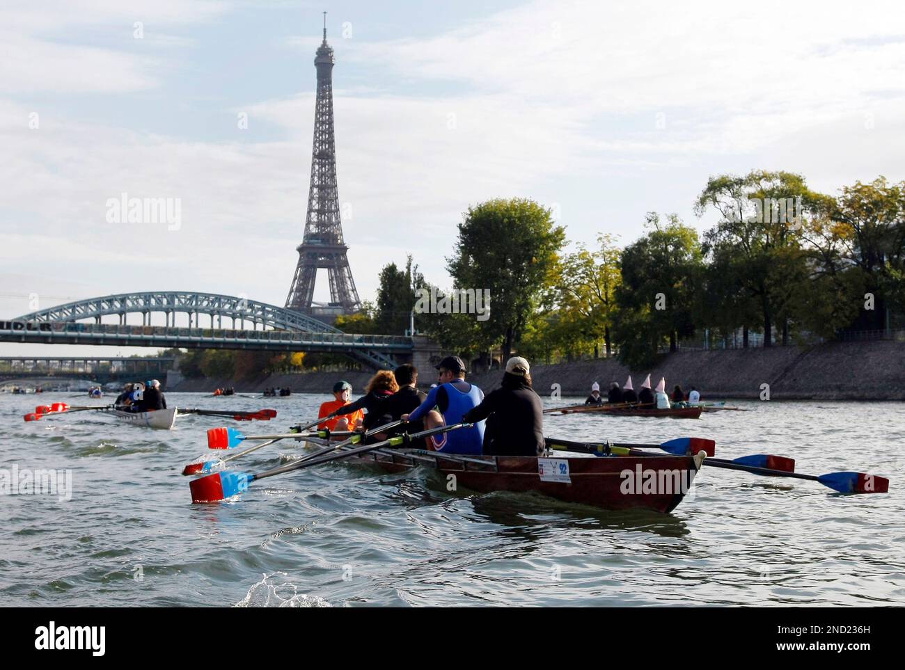Participants of the fun rowing competition Crossing Paris on The Seine ...