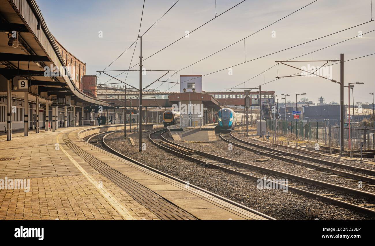 A view of a railway station with rails leading towards two trains ...