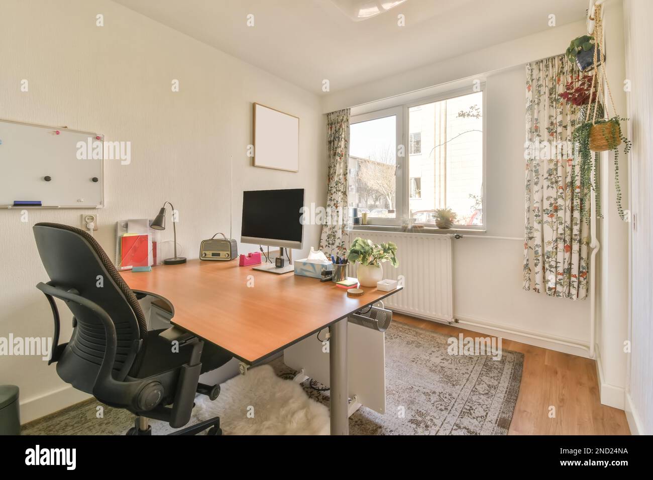 Interior design of room with wooden desk and computer placed on carpet ...
