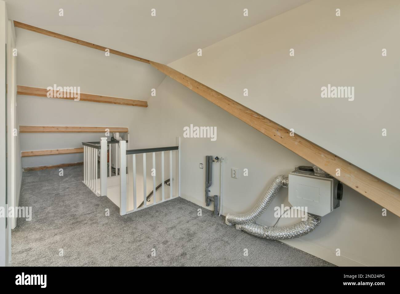 Interior design of contemporary attic with staircase and equipment ...