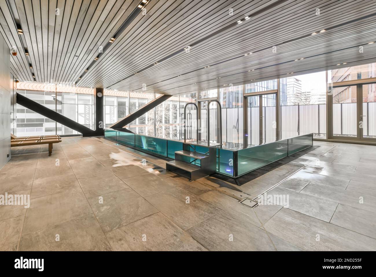 Interior of spacious room with swimming pool and steps surrounded by ...