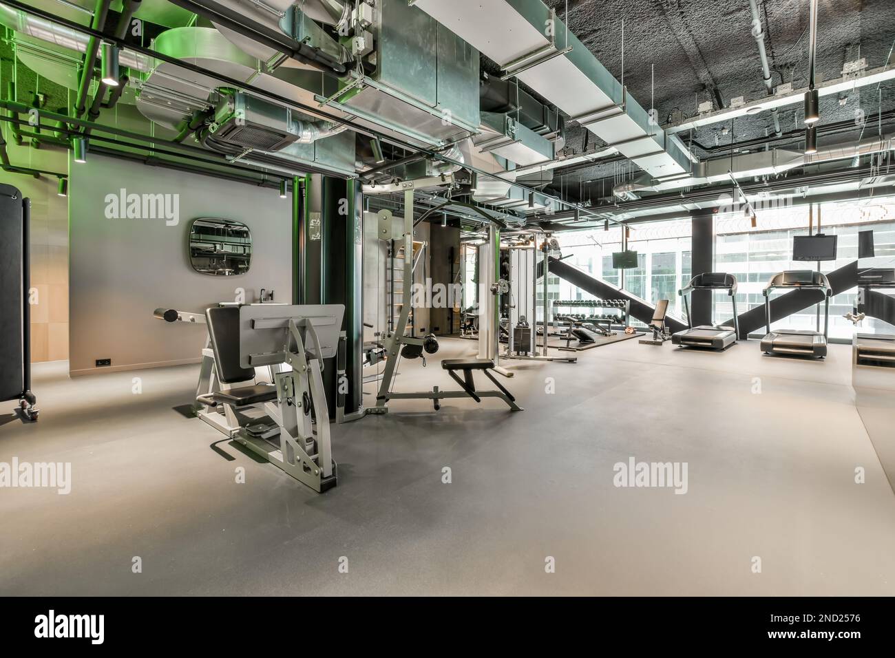 Interior of modern spacious gym with special equipment and machine ...