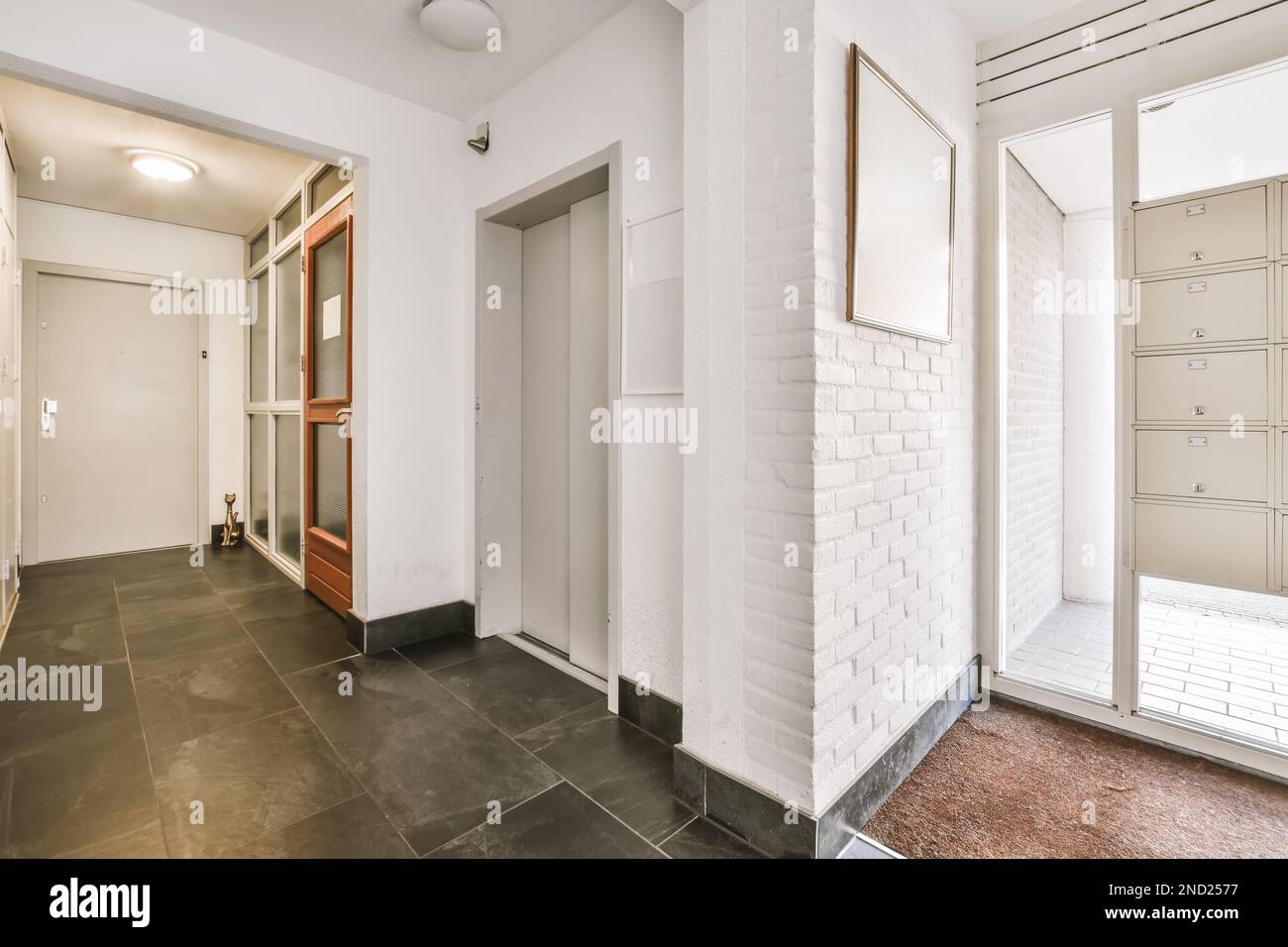 Interior of contemporary apartment building with elevator and glass ...