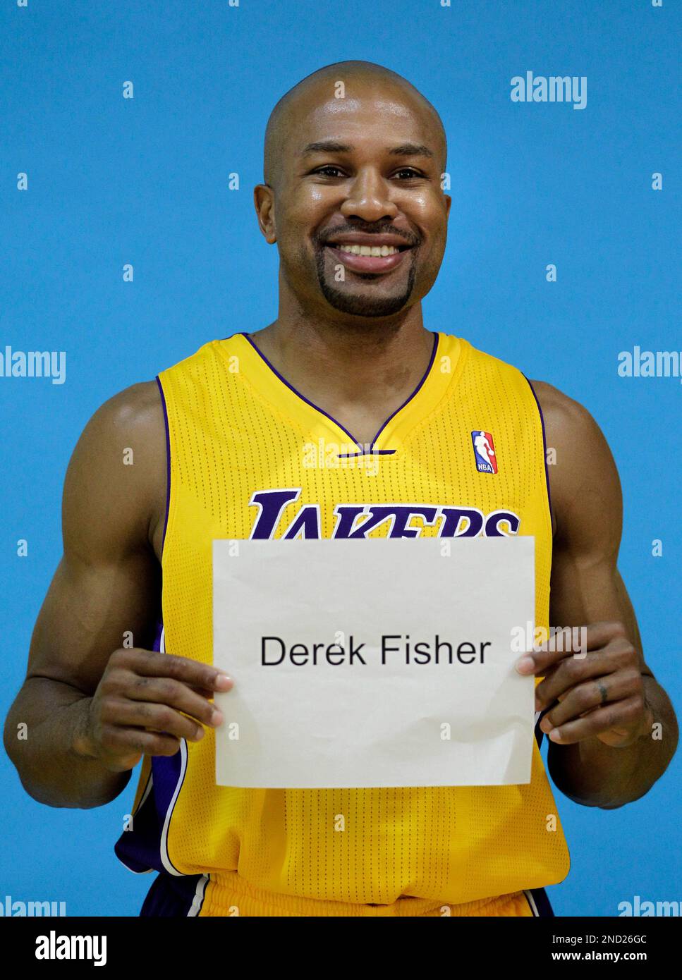 Los Angeles Lakers' Derek Fisher holds his name card for photos during ...