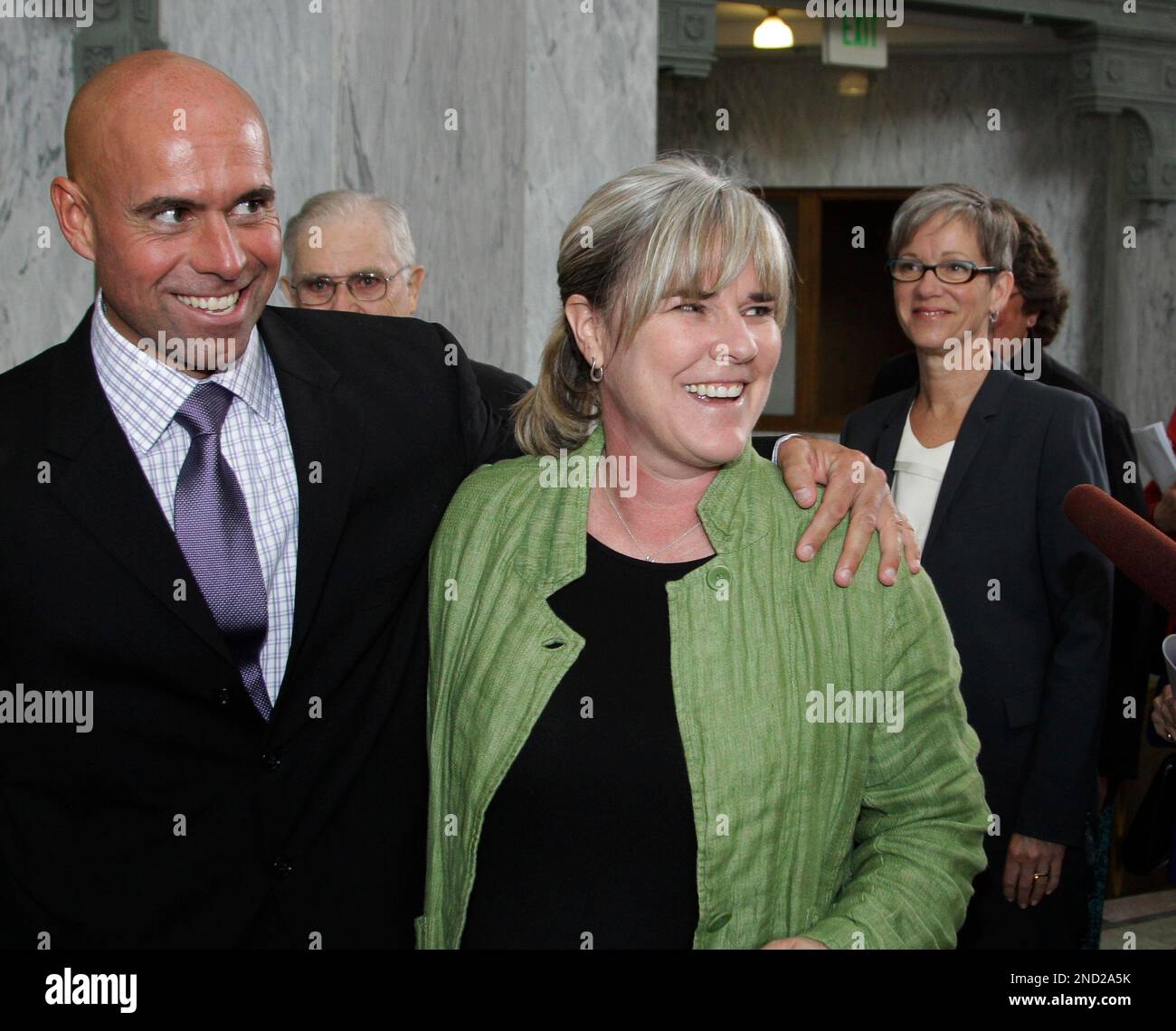 Margaret Witt, center, stands with Air Force Lt. Col. Victor Fehrenbach ...
