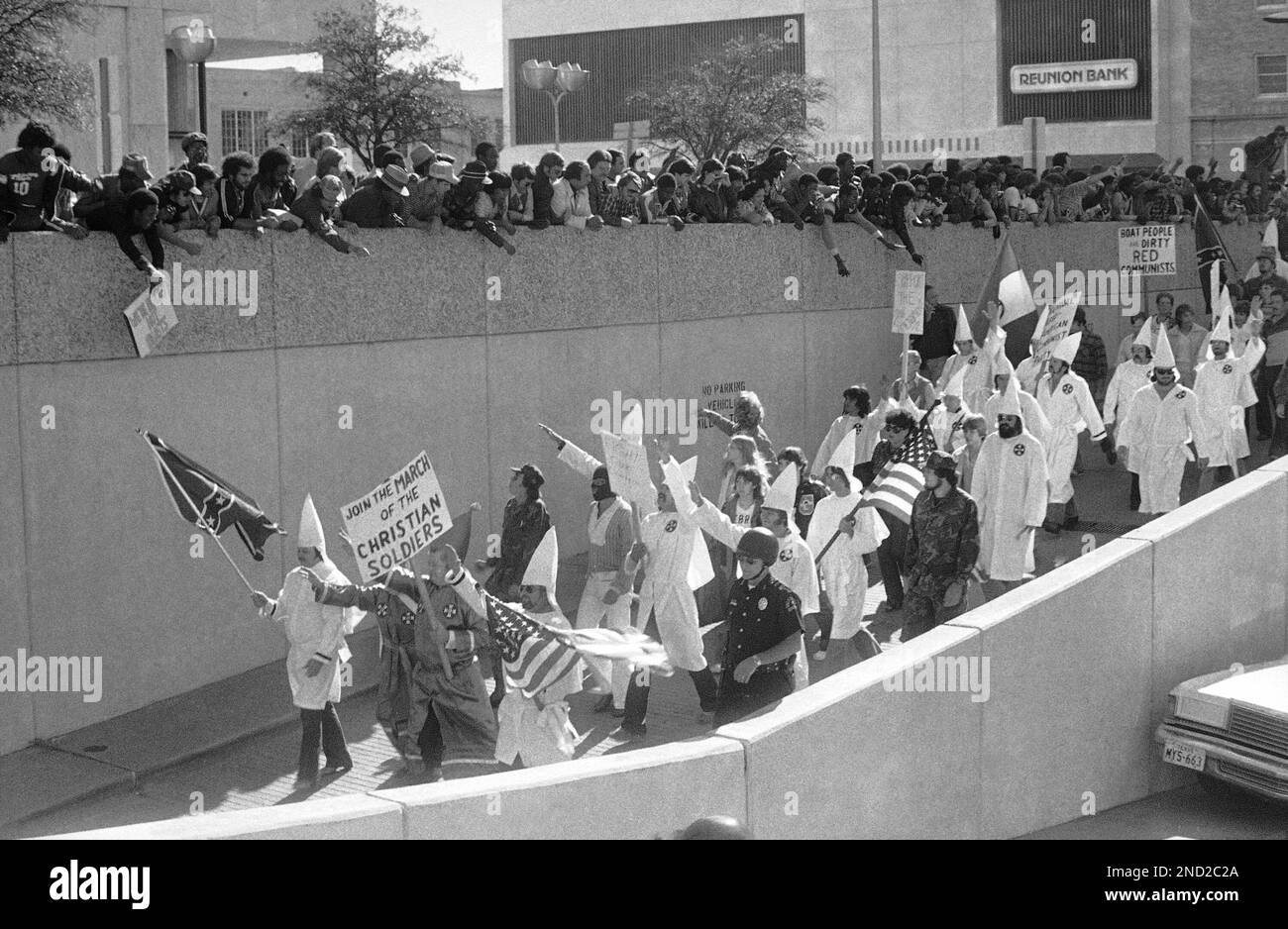 Hecklers jeers are returned by waving Ku Klux Klan members as they walk ...