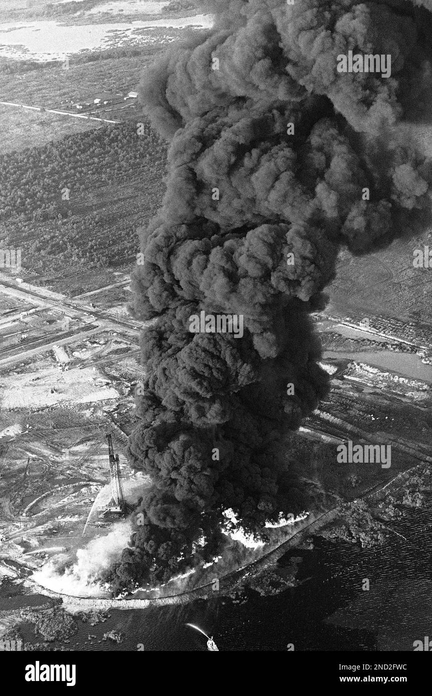 Smoke billows hundreds of feet in the air from and underground oil ...