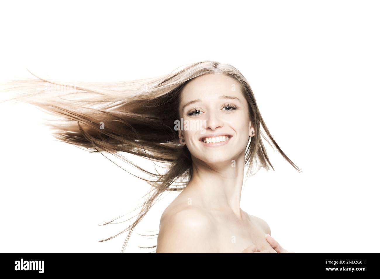 brunette girl with flowing hair in the air studio portrait against ...