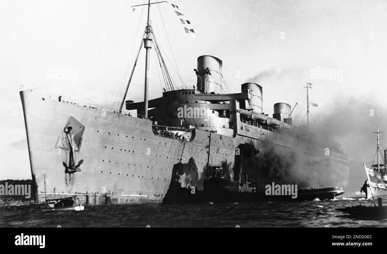 Her proud lines covered by a dull gray paint, the huge British liner ...