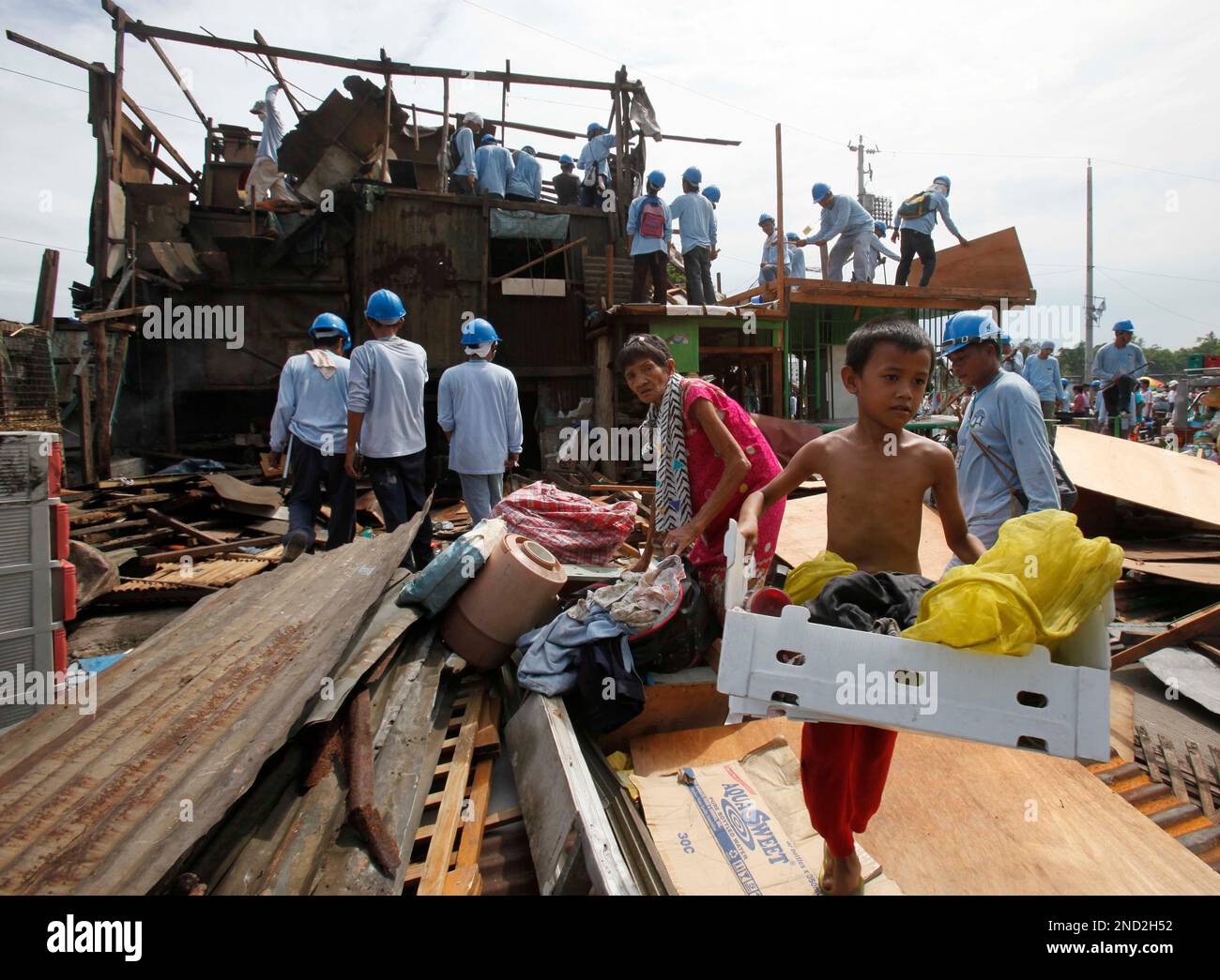 Residents carry their belongings and other household items as ...