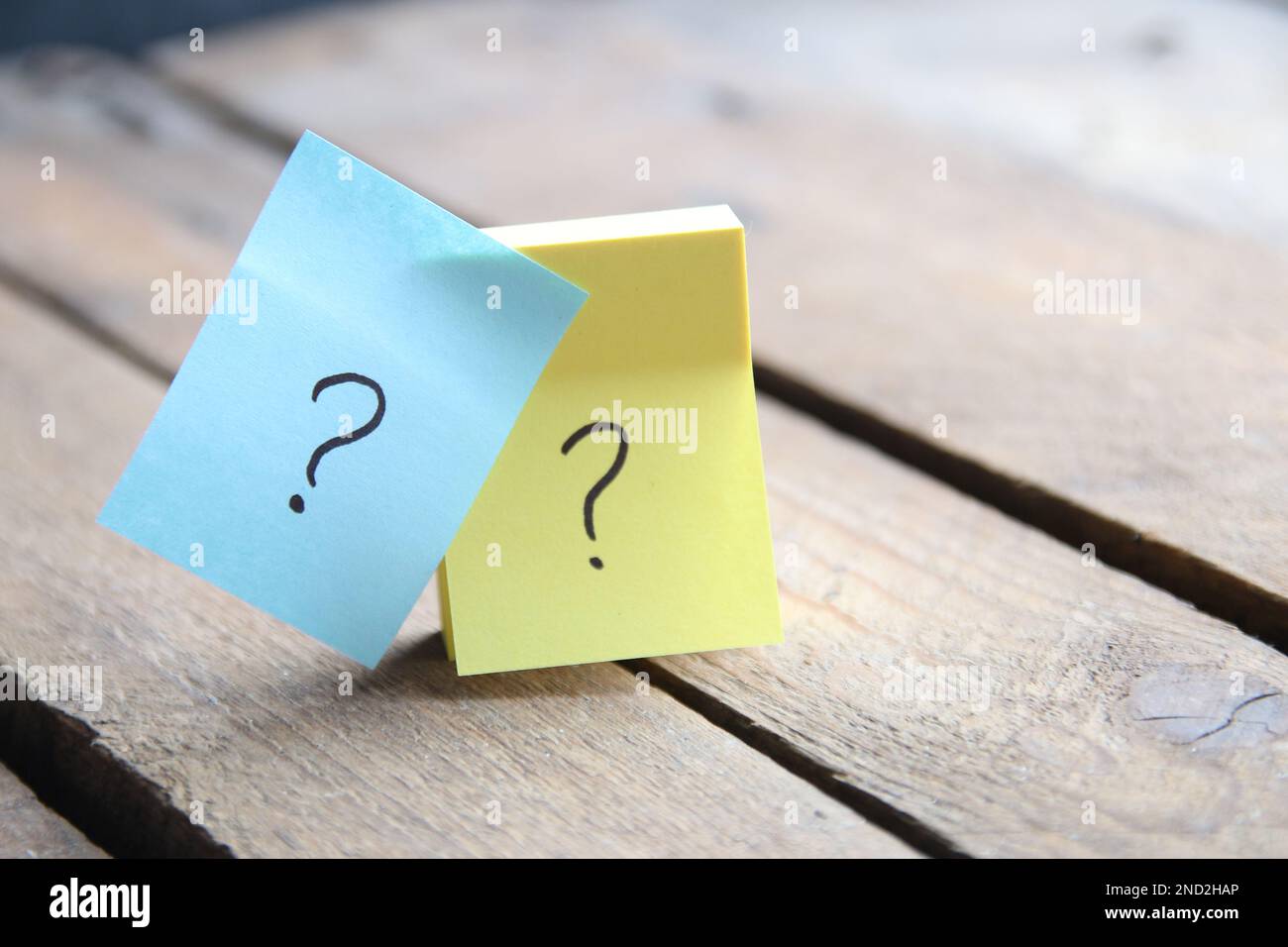 Large Question marks on cards on a wooden background Stock Photo - Alamy