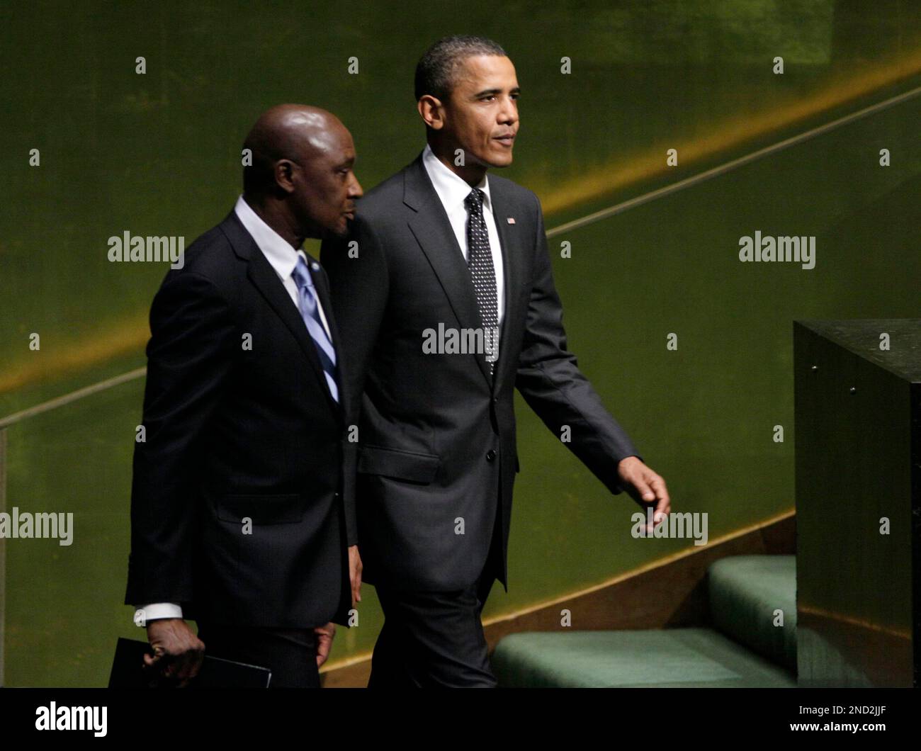 President Barack Obama, right, walks to the podium to address a summit ...
