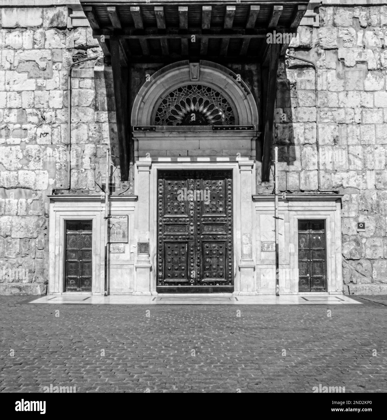 A black and white shot of the Omayyad mosque main entrance in the old ...