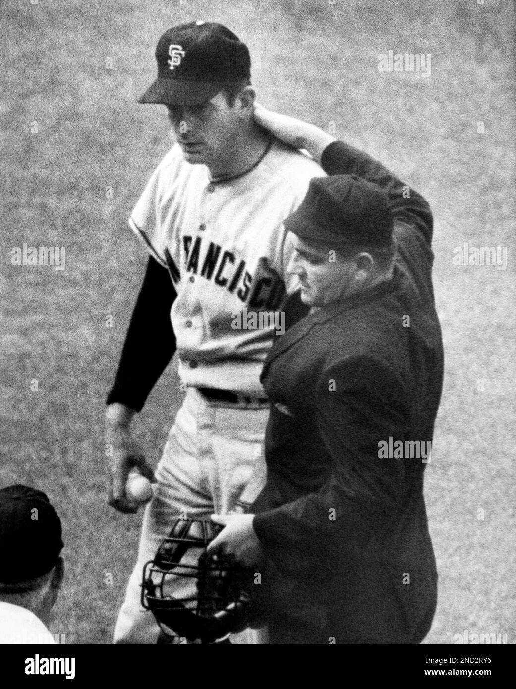 Umpire Bob Engel reaches up to pat the back of the neck of San ...