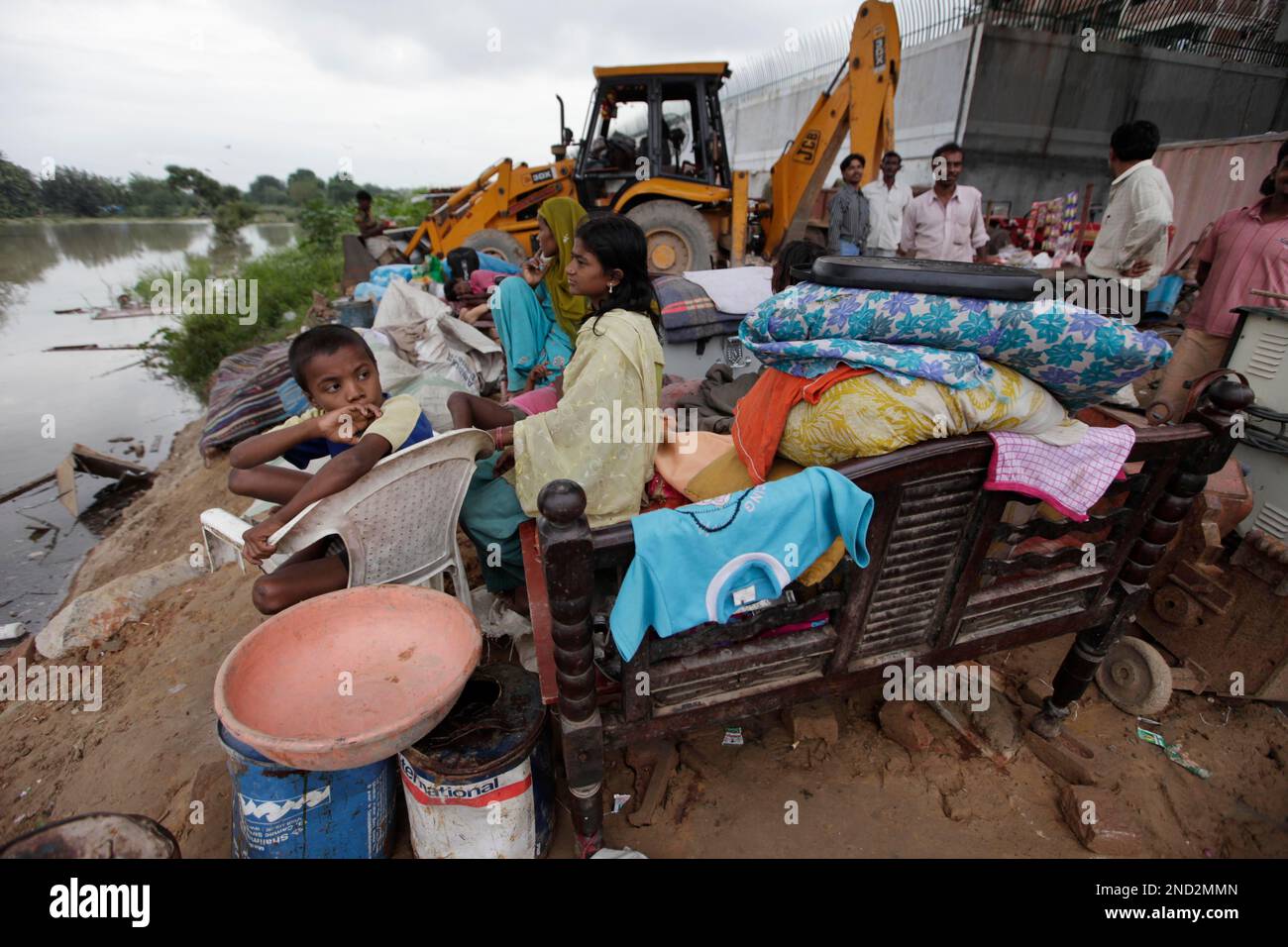 People who had to leave the banks of the overflowing Yamuna river, take ...