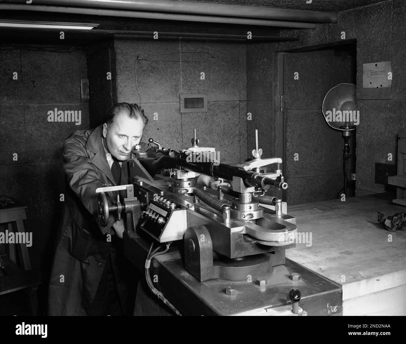 Burt Munhall tests a rifle for accuracy of sight as he makes ballistics ...