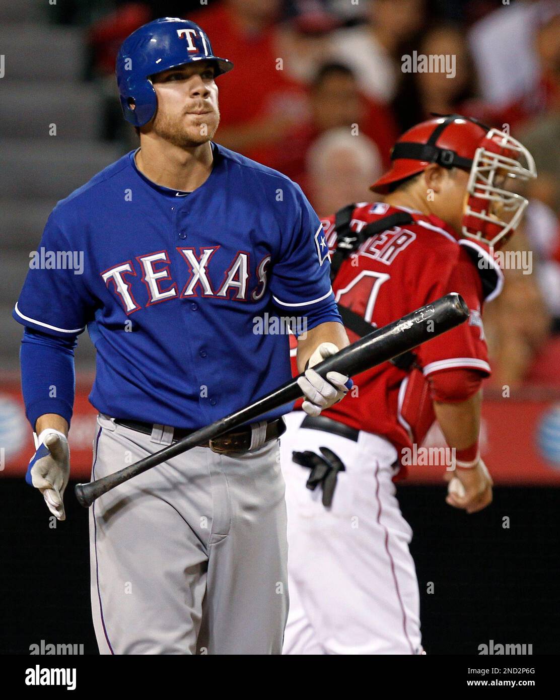 Texas Rangers' Chris Davis, left, reacts after striking out as Los ...