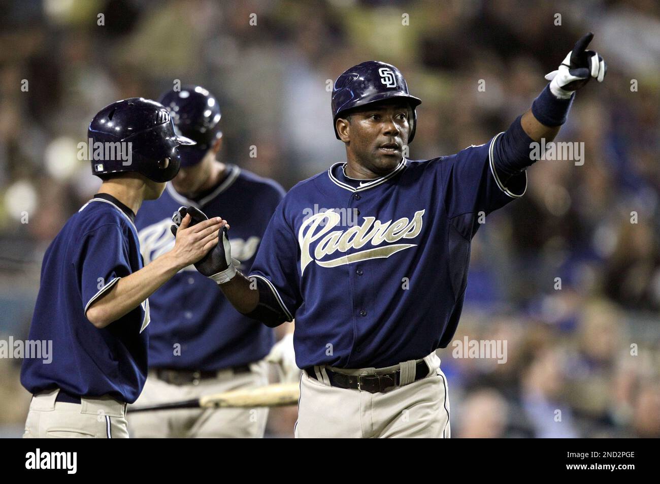 San Diego Padres' Miguel Tejada reacts after scoring on Ryan Ludwick's ...