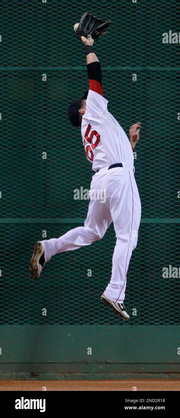 Boston Red Sox center fielder Ryan Kalish leaps but can't make the play ...