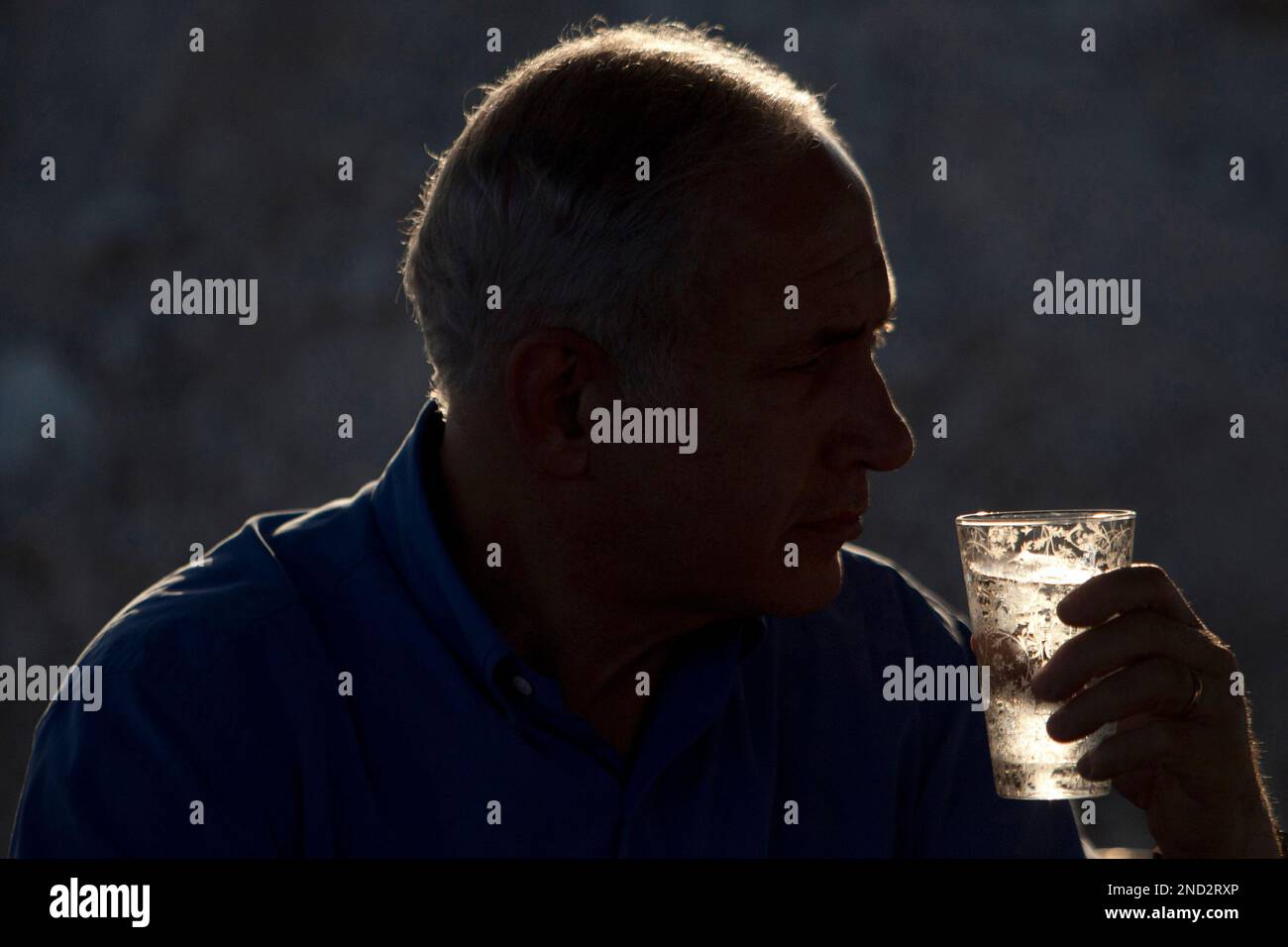 Israeli Prime Minister Benjamin Netanyahu holds a glass of water during ...