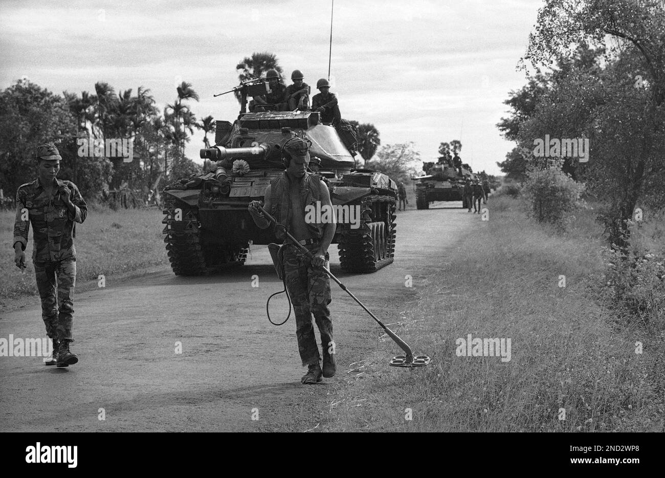South Vietnamese soldier preceding an armored column sweeps Route 7 for ...