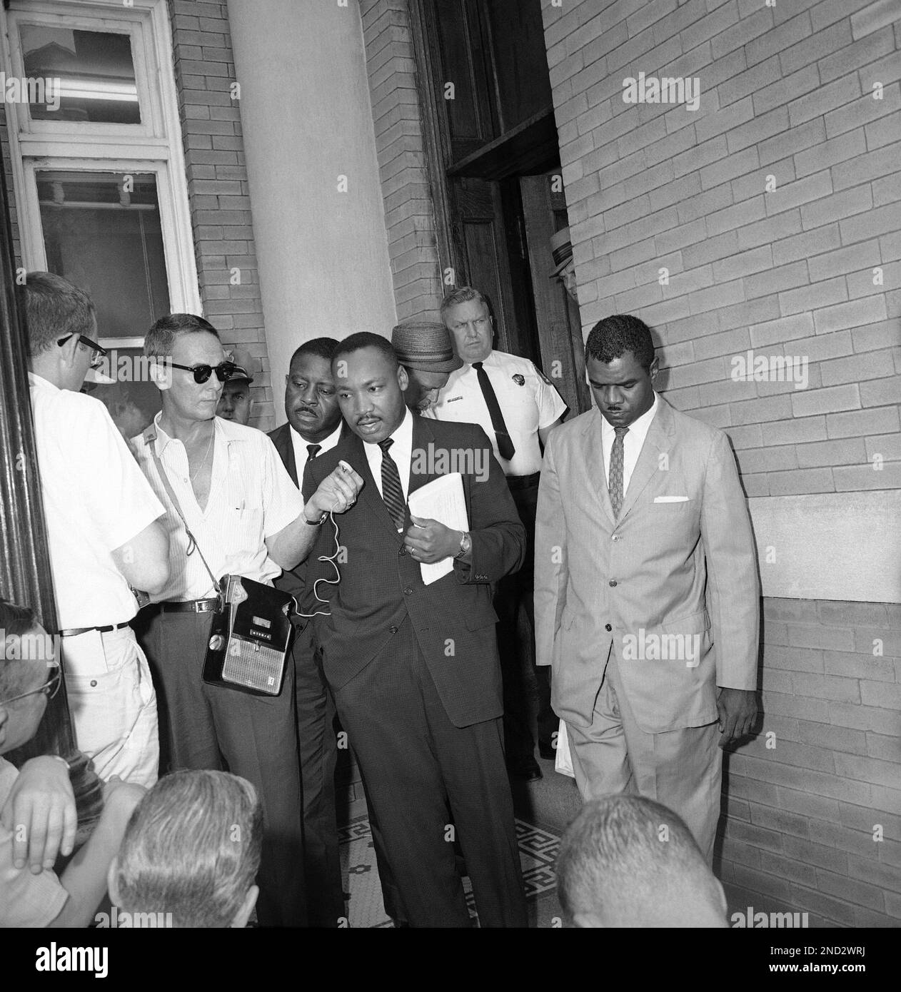 Martin Luther King, Jr., clutching a copy of a federal temporary ...