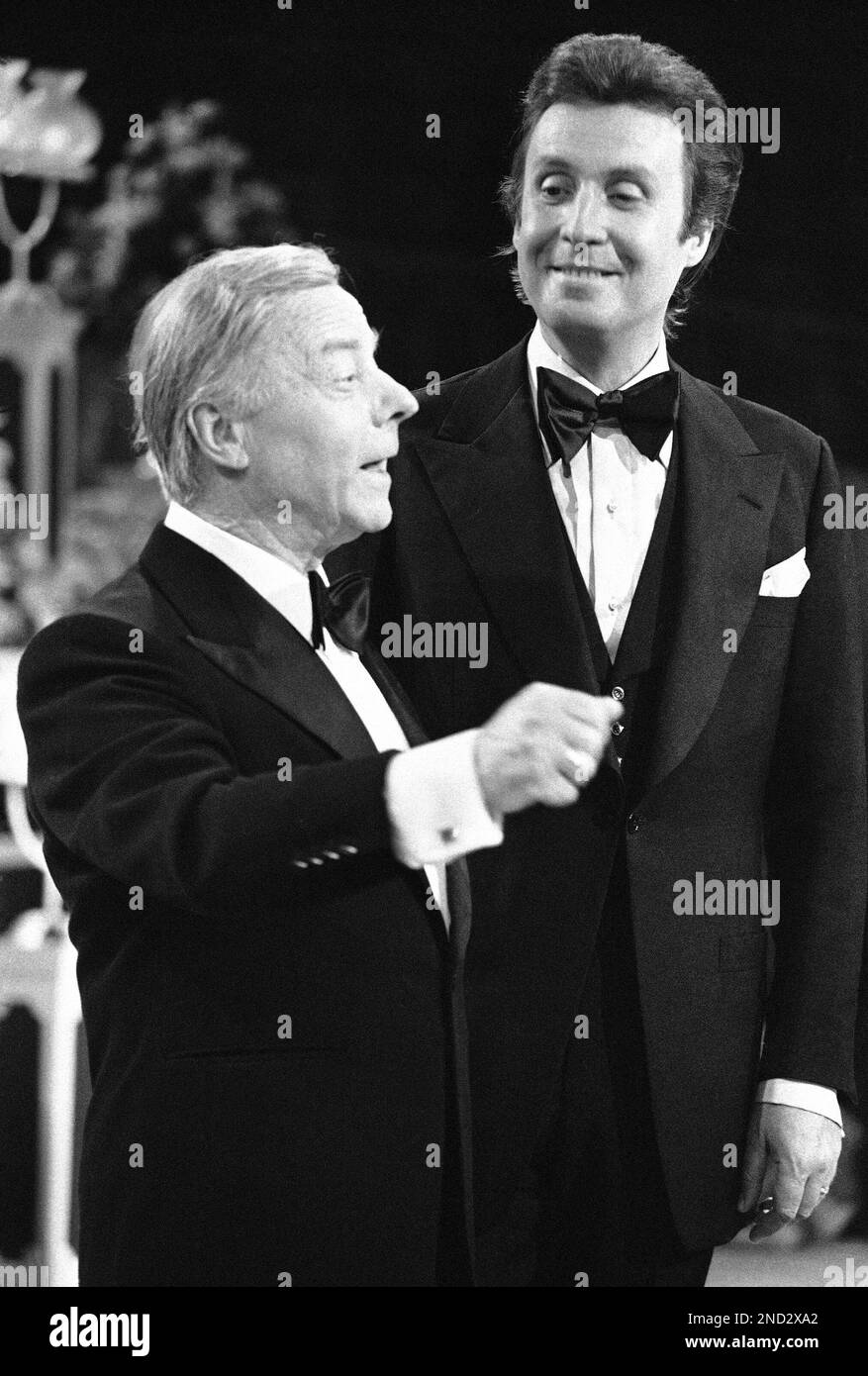 Austrian actor and singer Peter Alexander, right, watches German actor Heinz Ruehmann during a ...