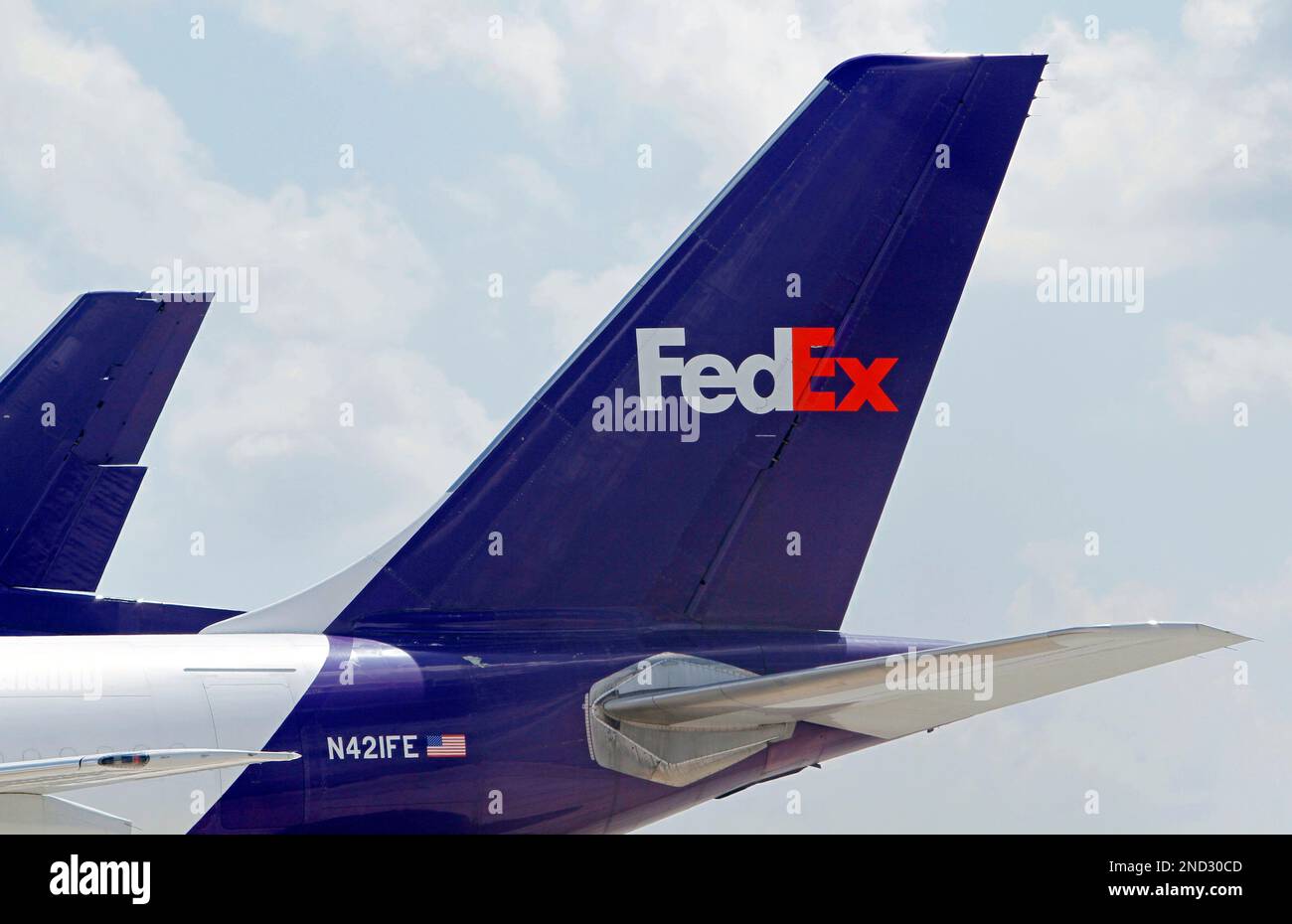 The tail of a FedEx cargo plane is shown at Miami International Airport ...