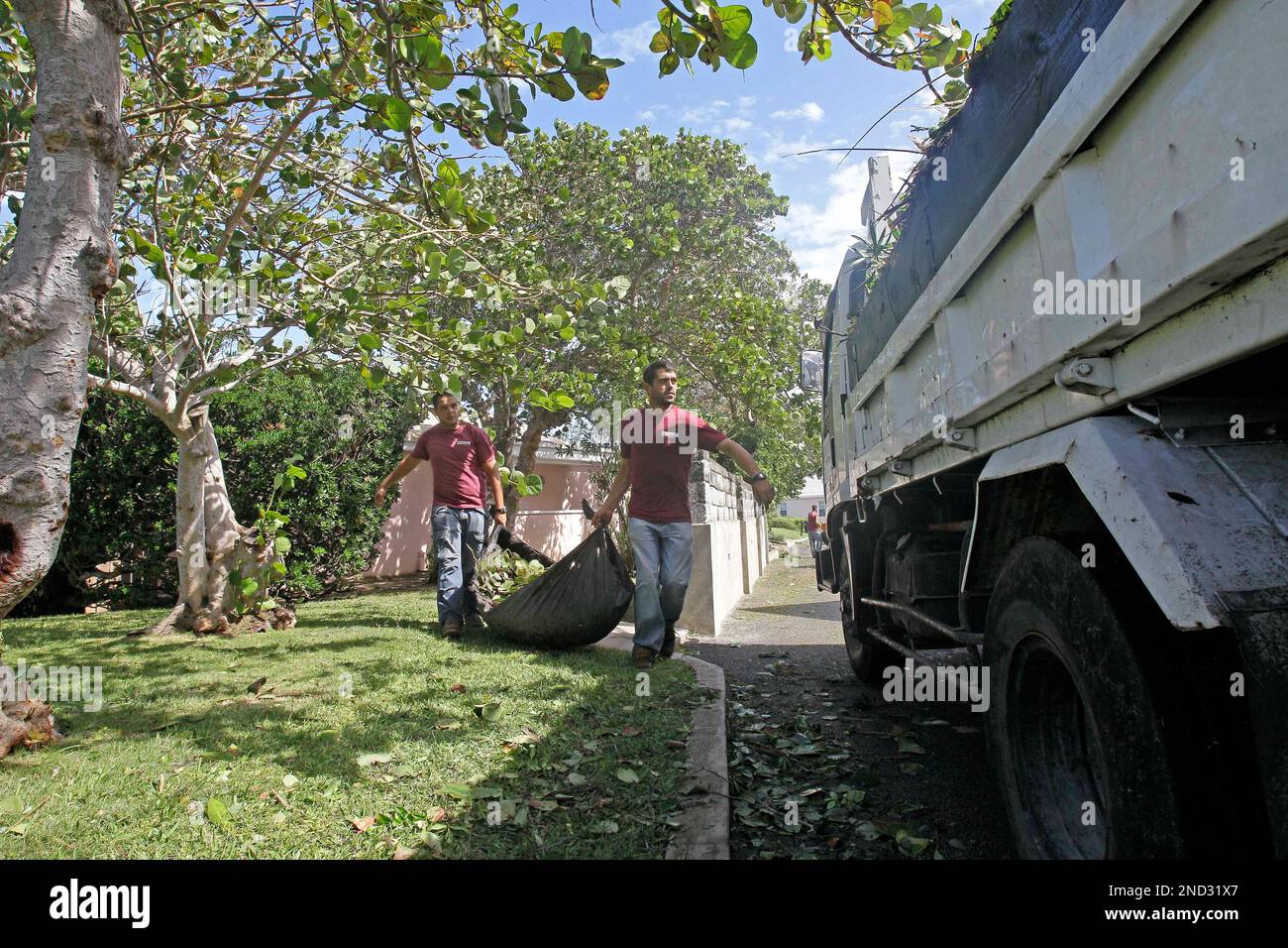 Workers at Cambridge Beaches in Sandys Parish clean up debris following ...