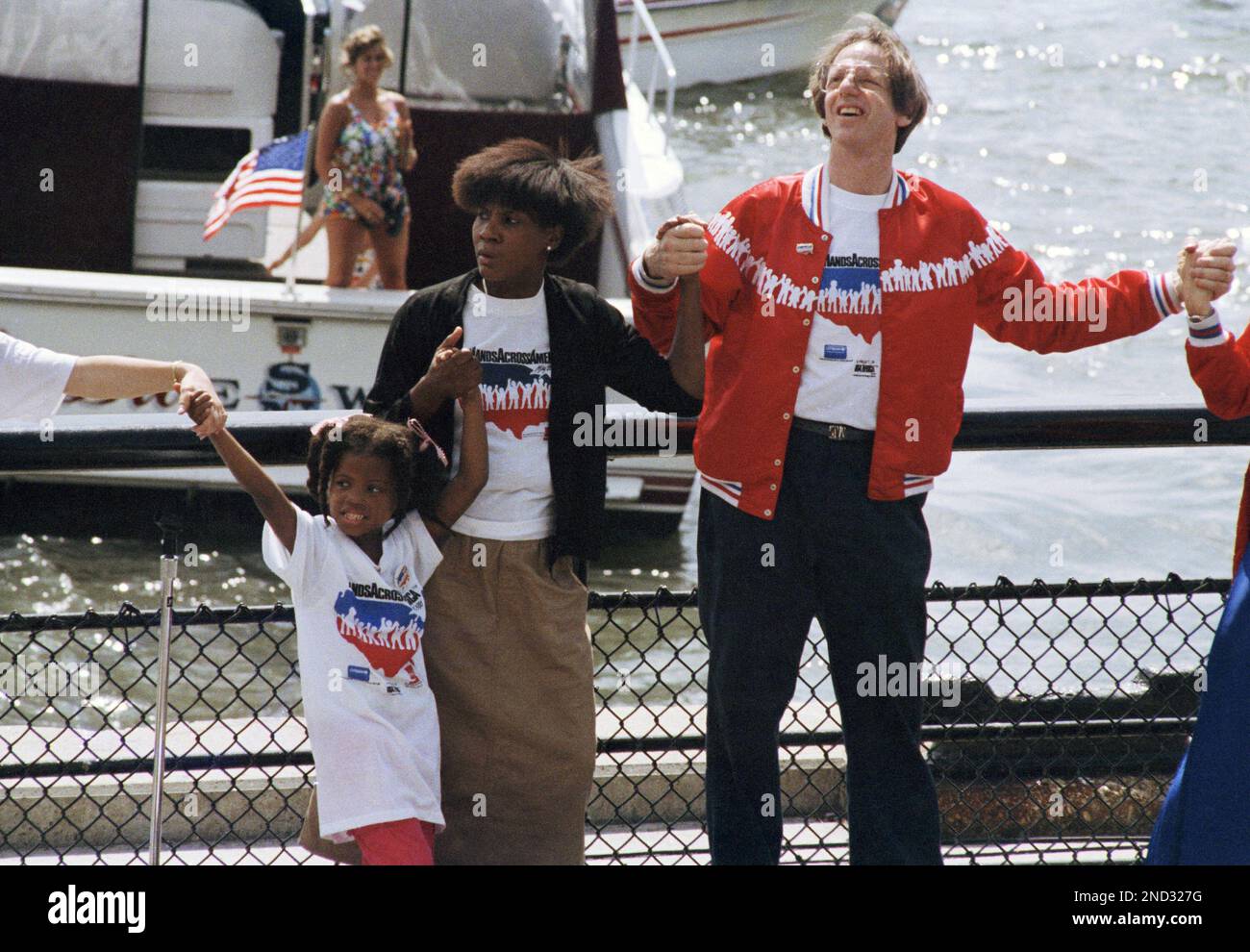 Ken Kragen, organizer of the Hands Across America event, joins hands with Jean Sherwood, of ...