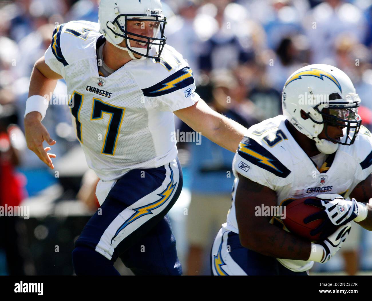 San Diego Chargers quarterback Philip Rivers, left, hands off the ball ...