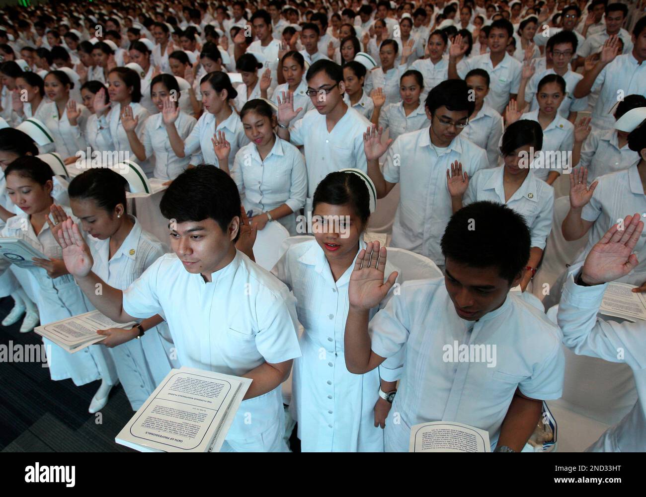 New Filipino professional nurses take their oaths during a ceremony at ...